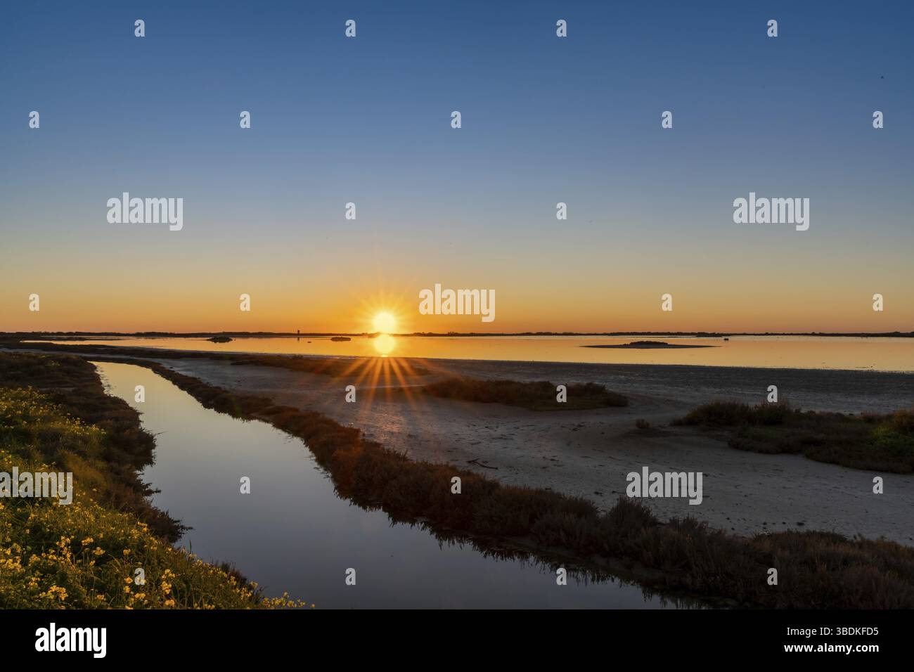 Beautiful sunset over wetlands and marshlands with a colorful sky and a ...