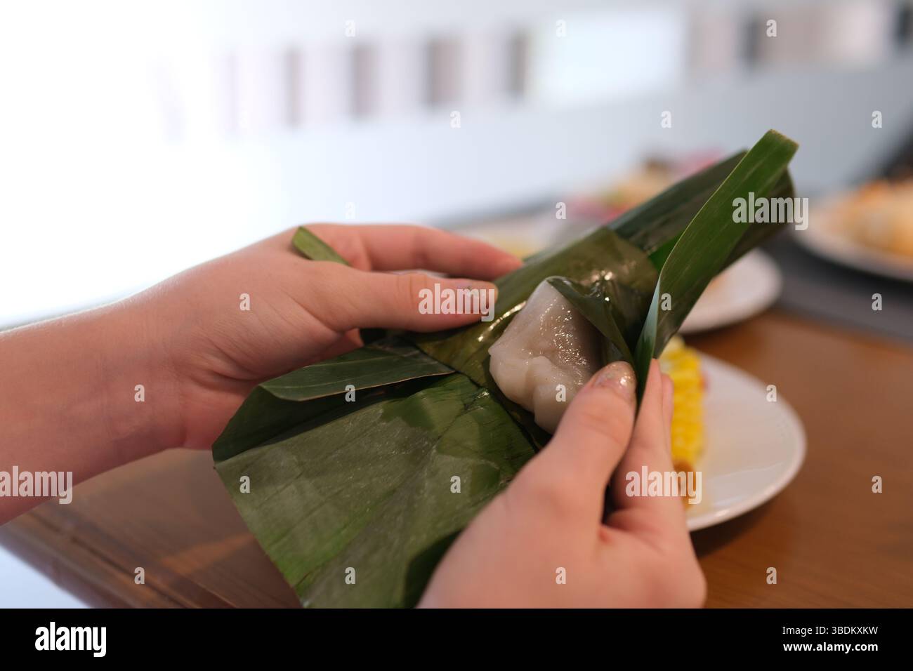 Traditional cake wrapped in banana leaves shaped like a cone, called ...