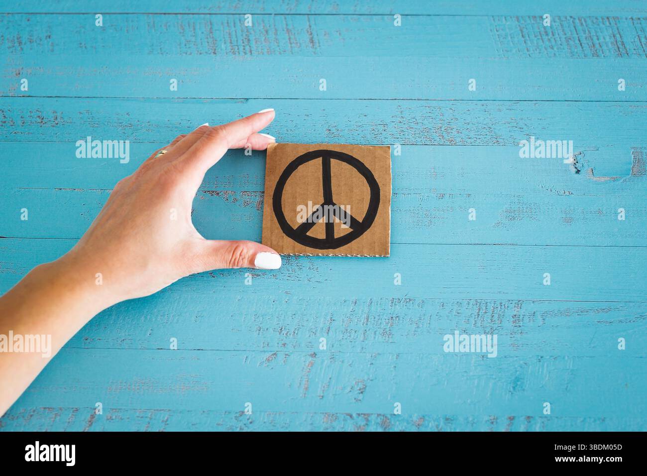 hand holding peace sign on a piece of cardboard, concept of world peace ...