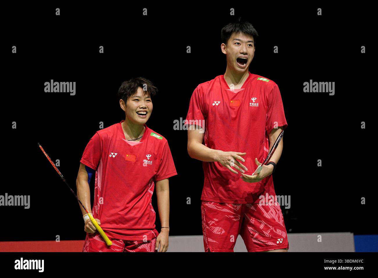 China's Feng Yan Zhe, right and Huang Dong Ping react during their ...