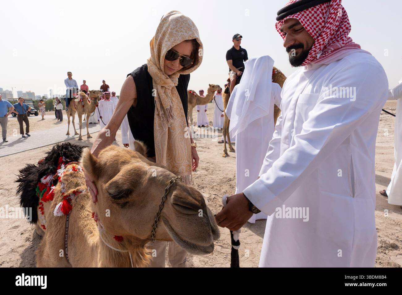 Homeland Security Secretary Kristi Noem pets a camel before a tour of ...