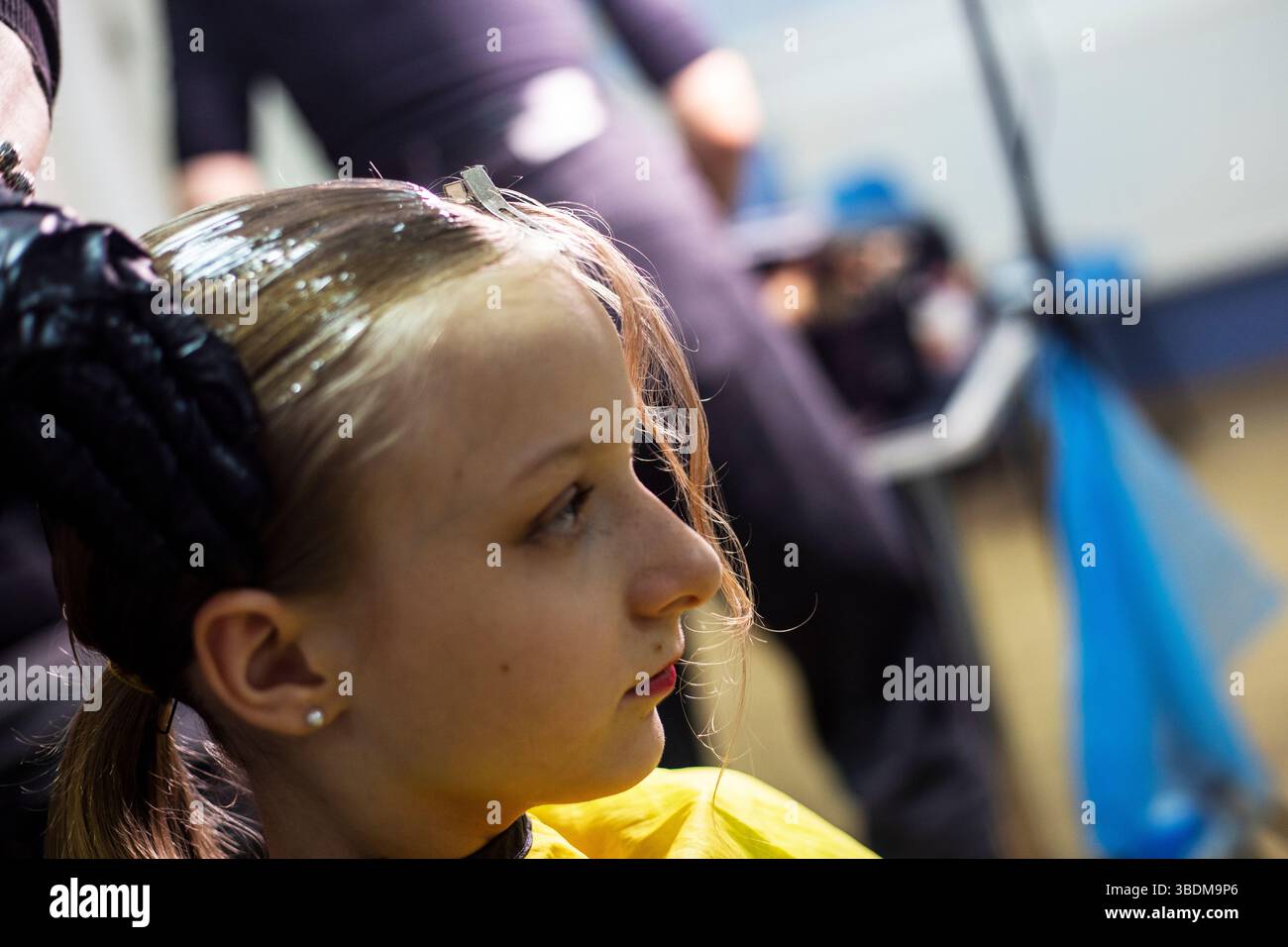 master creates and fixes a slicked-back hairstyle for a ballroom ...