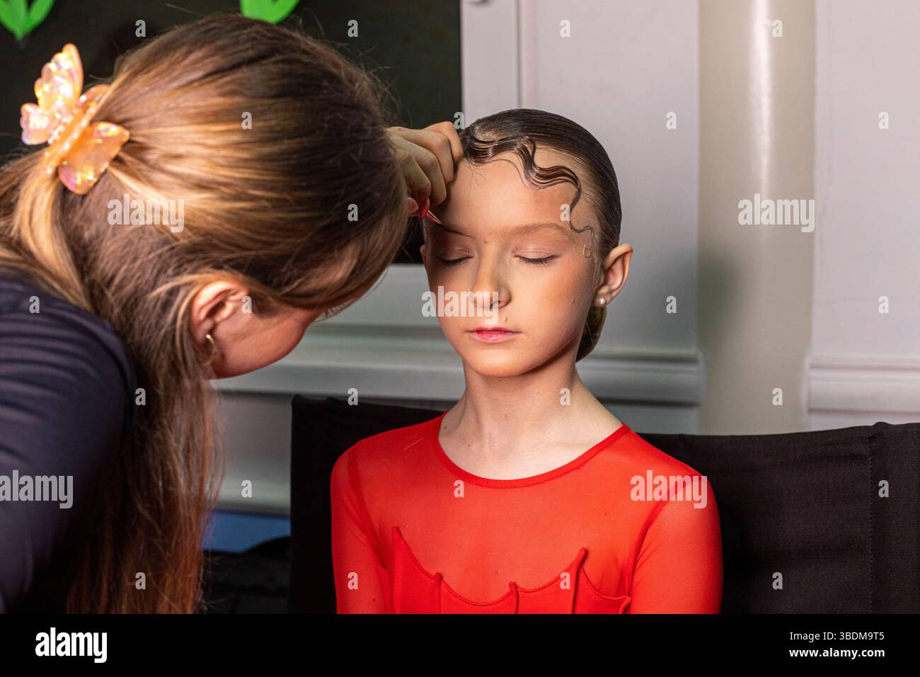 master creates professional makeup for a girl in ballroom dancing ...
