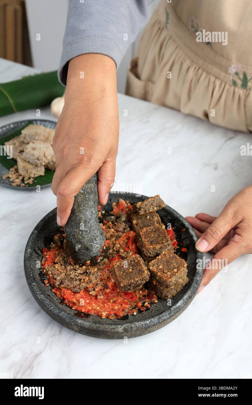 Female Hand Crushed ROasted Oncom on the Chilli, Step making Sambal ...