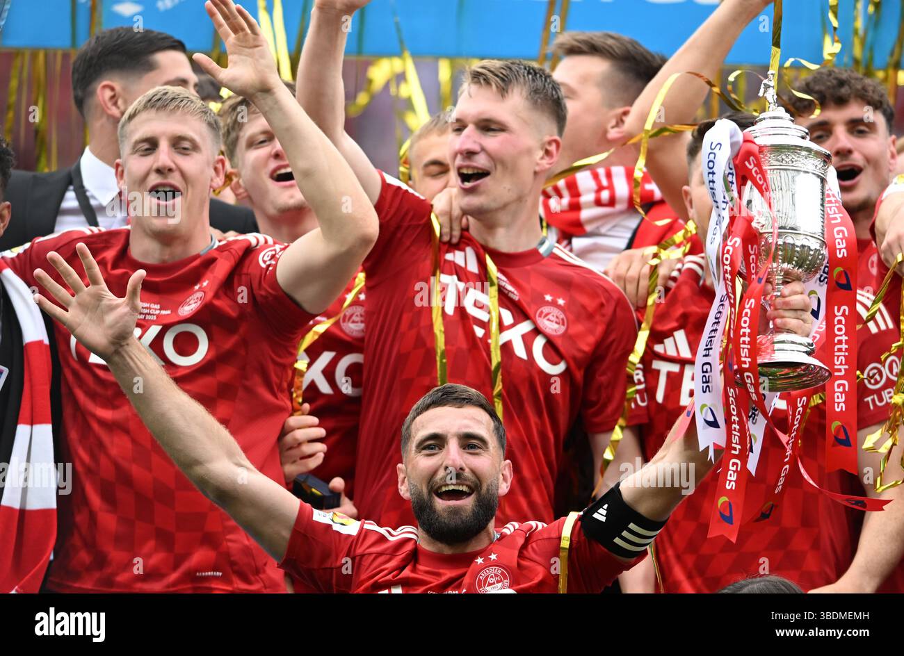 Glasgow, UK. 24th May, 2025. Graeme Shinnie of Aberdeen holds up the ...