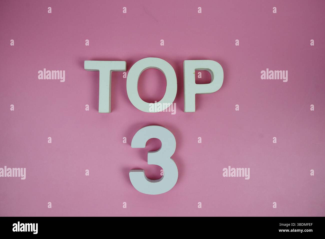 Top 3 alphabet letters top view on pink background Stock Photo - Alamy