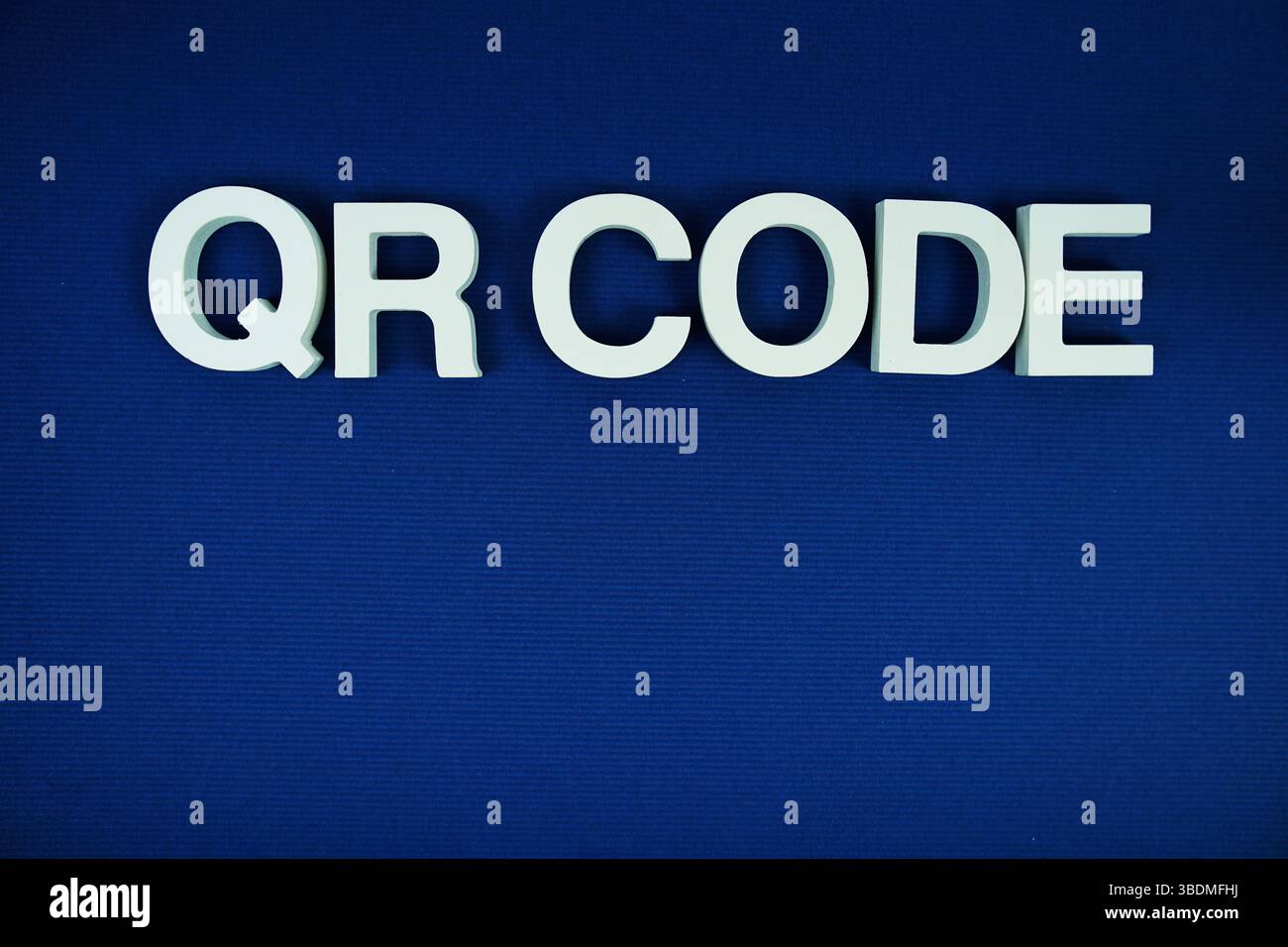 QR Code alphabet letters with space for text top view on navy blue ...