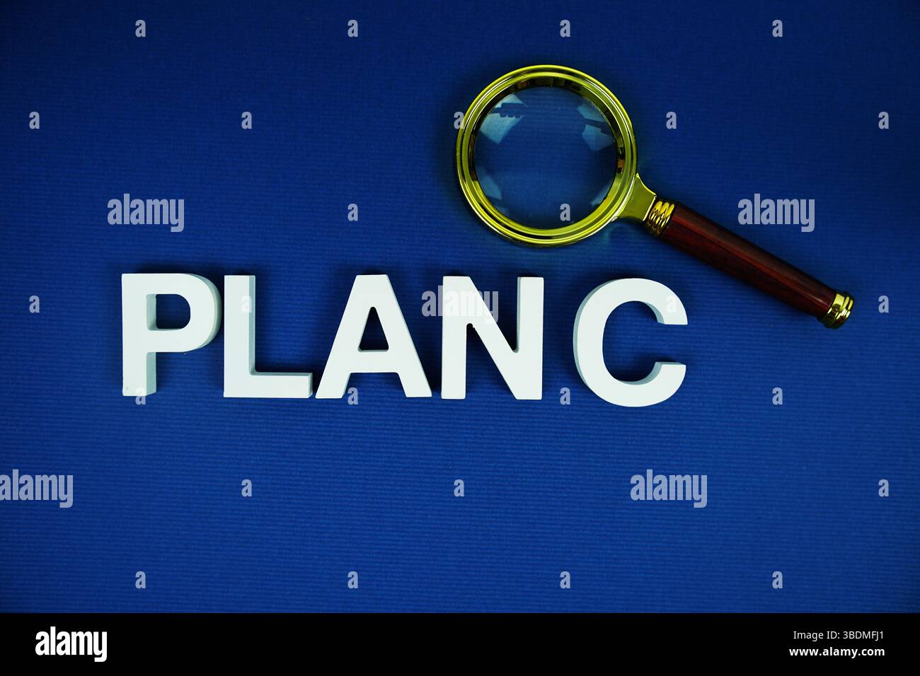 Plan C alphabet letters with magnifying glass top view Stock Photo - Alamy