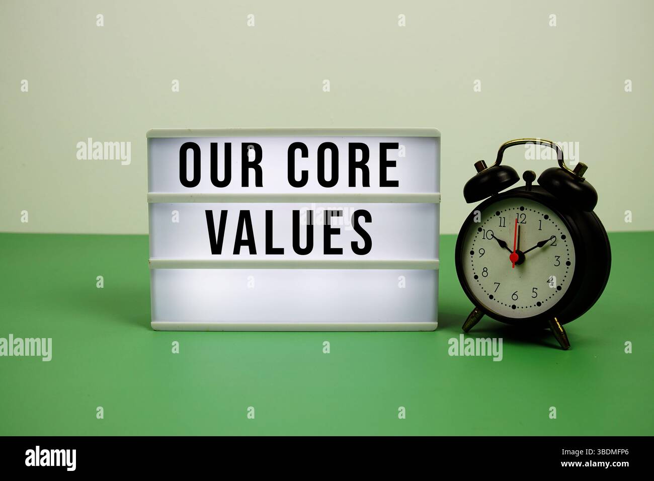 Our Core Values text on light box with alarm clock on green background ...