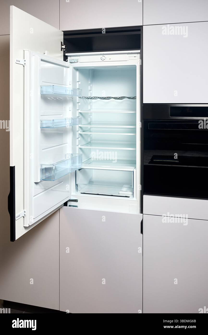 Vertical shot of kitchen interior with beige wooden furniture and ...