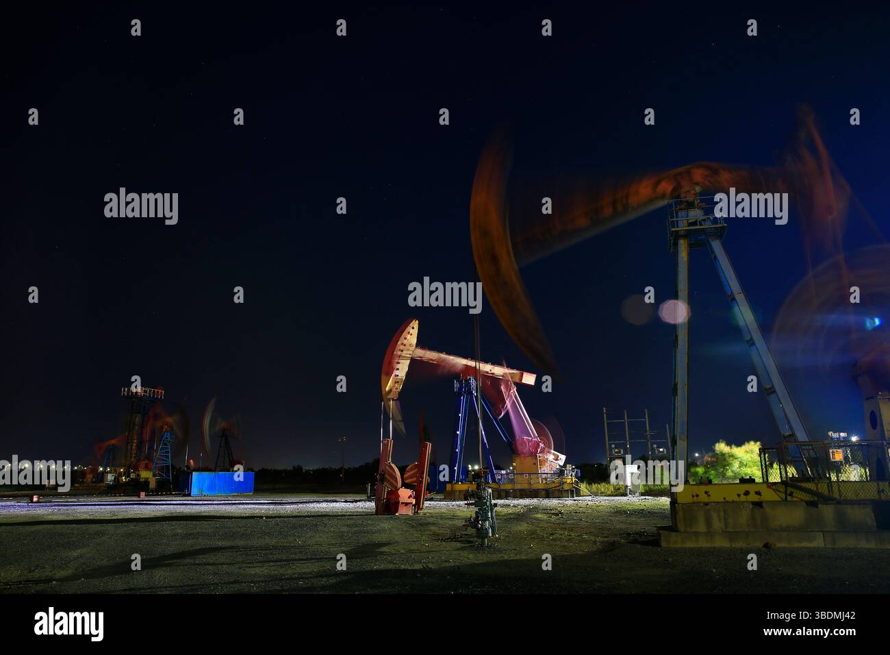 Pump platform for oil production in oil field at night.Oil and gas ...
