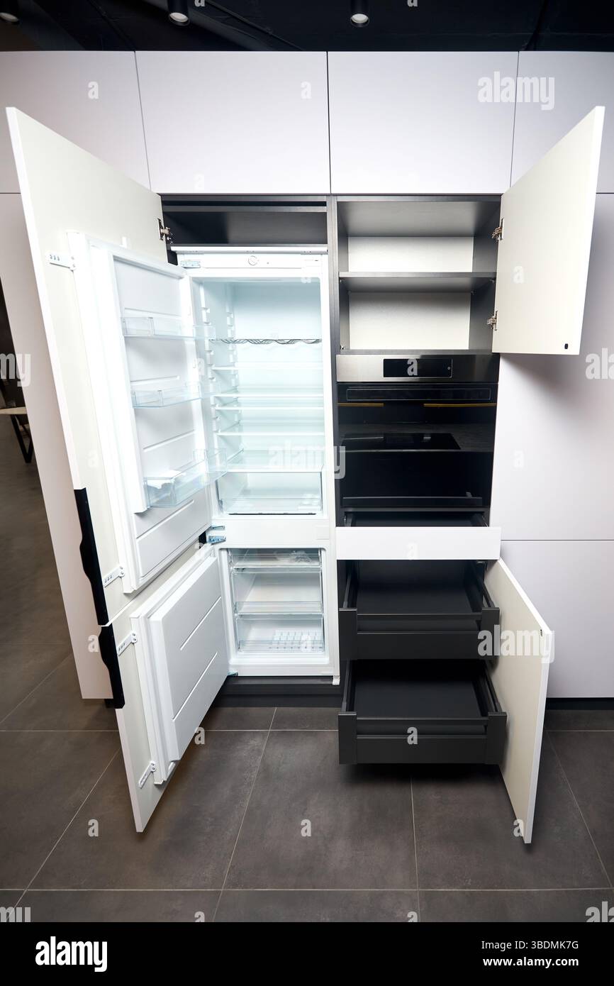 Vertical shot of kitchen interior with beige wooden furniture and ...