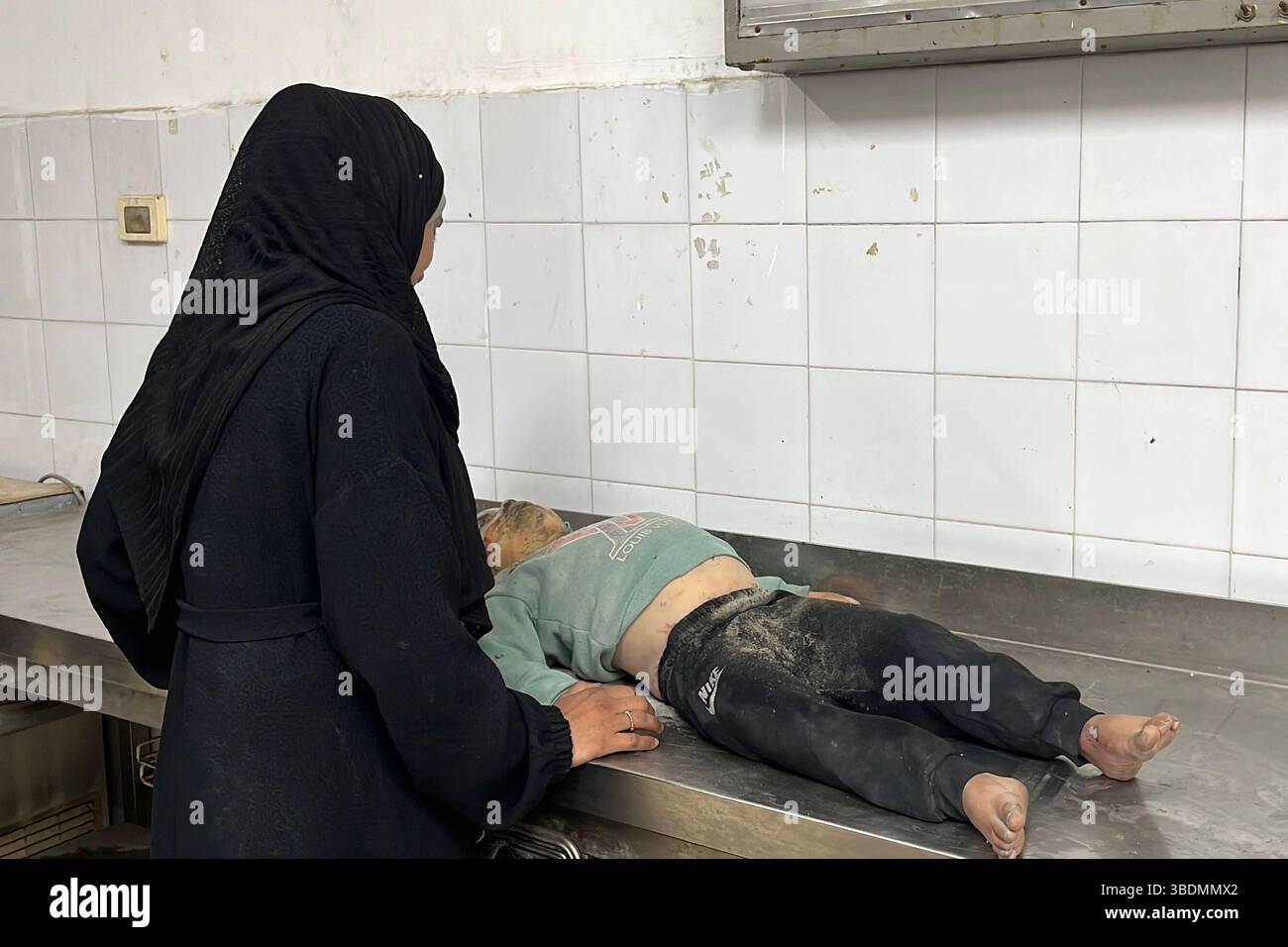 Relatives of Palestinians who lost their lives mourn after the Israeli ...