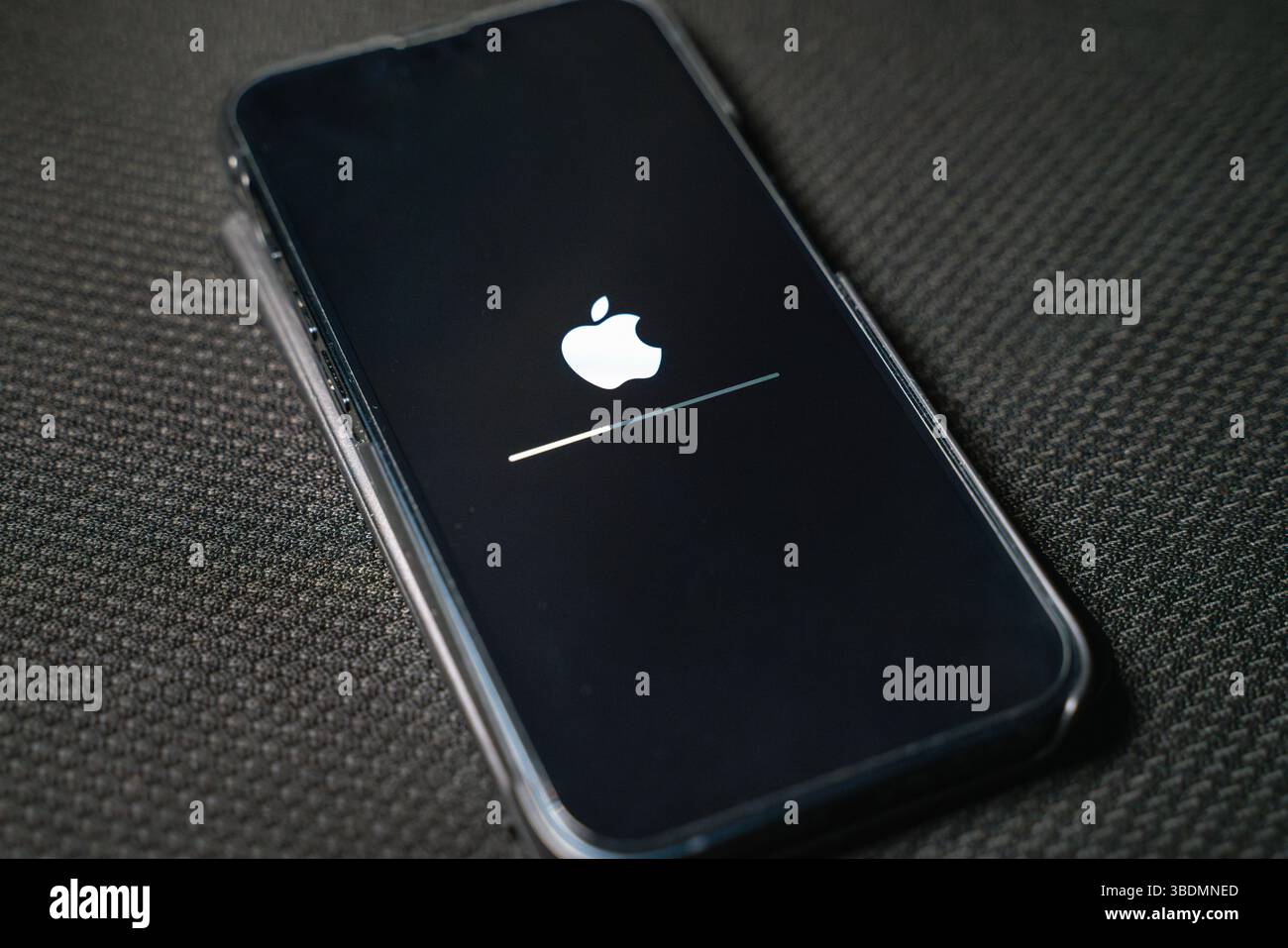 iPhone displays the iconic white Apple logo against a black background ...