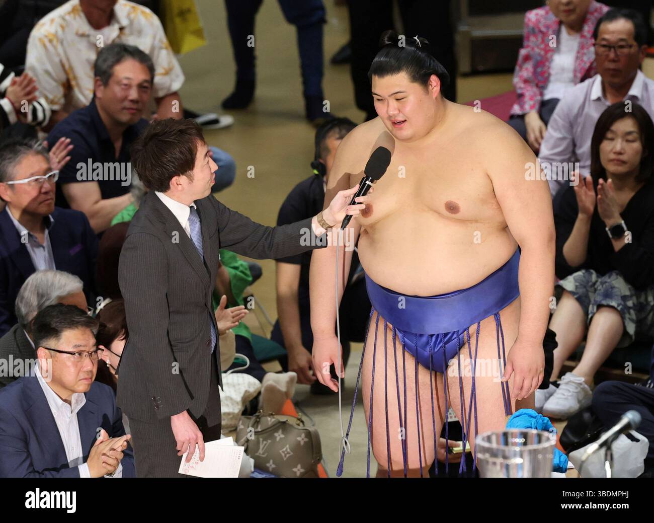 Ozeki Onosato (R) gives victory interview after the award ceremony of the May Grand Sumo ...