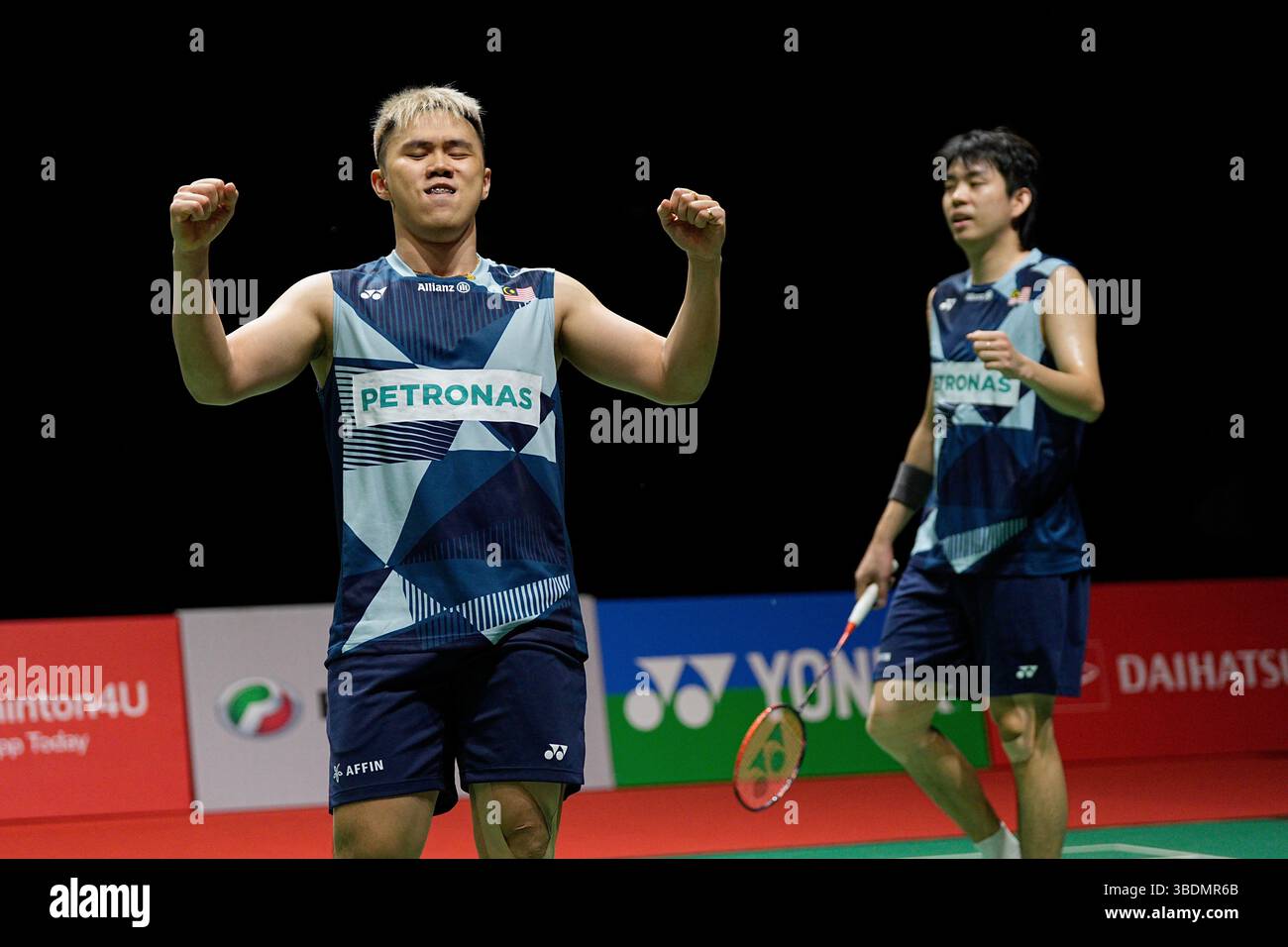 Malaysia's Tee Kai Wun, left, and Man Wei Chong celebrate after defeating compatriots Aaron Chia ...