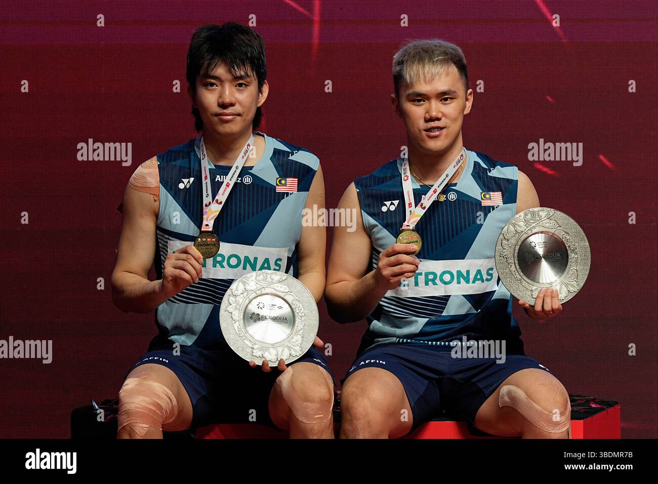Winners Man Wei Chong and Tee Kai Wun pose on the podium during the awards ceremony for the men ...