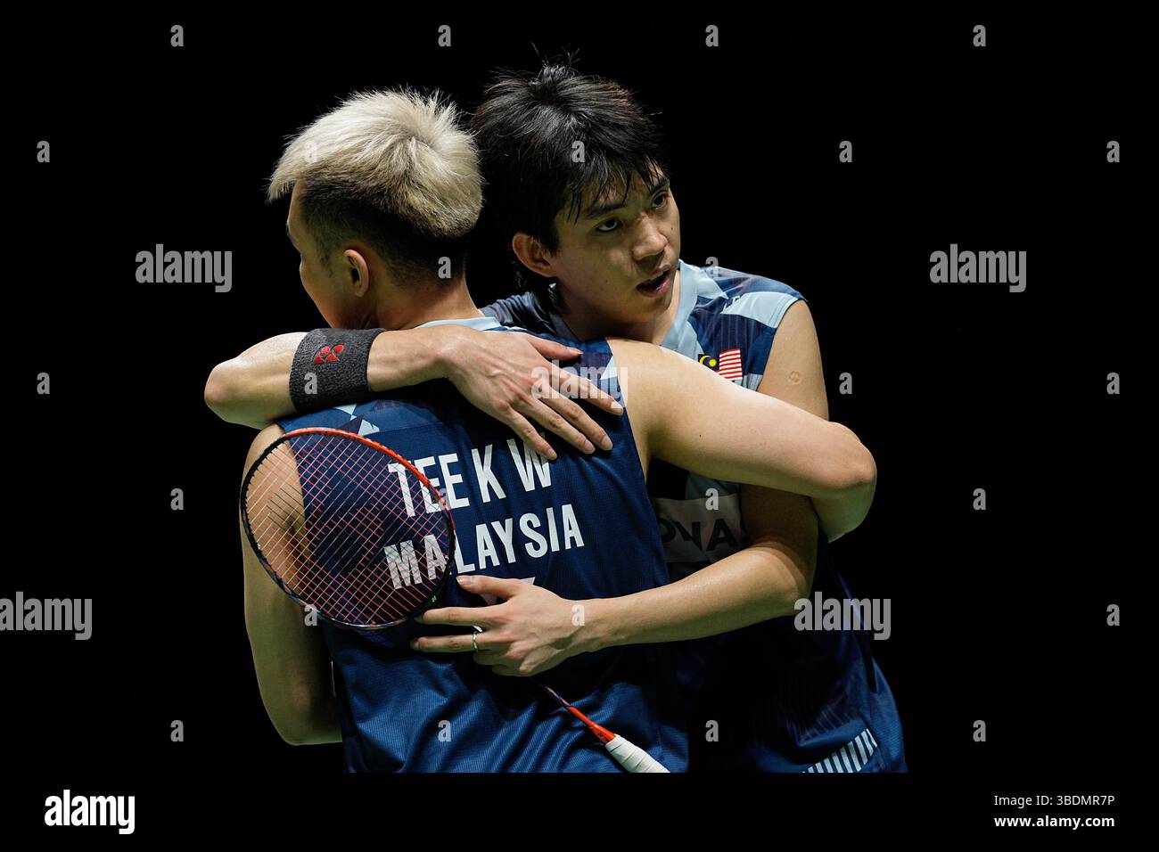 Malaysia's Man Wei Chong, right, and Tee Kai Wun celebrate after defeating compatriots Aaron ...