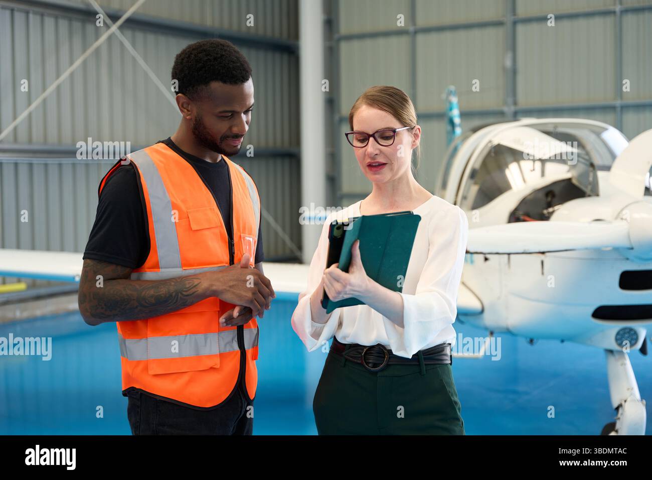 Flight instructor showing aircraft maintenance to trainee pilot Stock ...