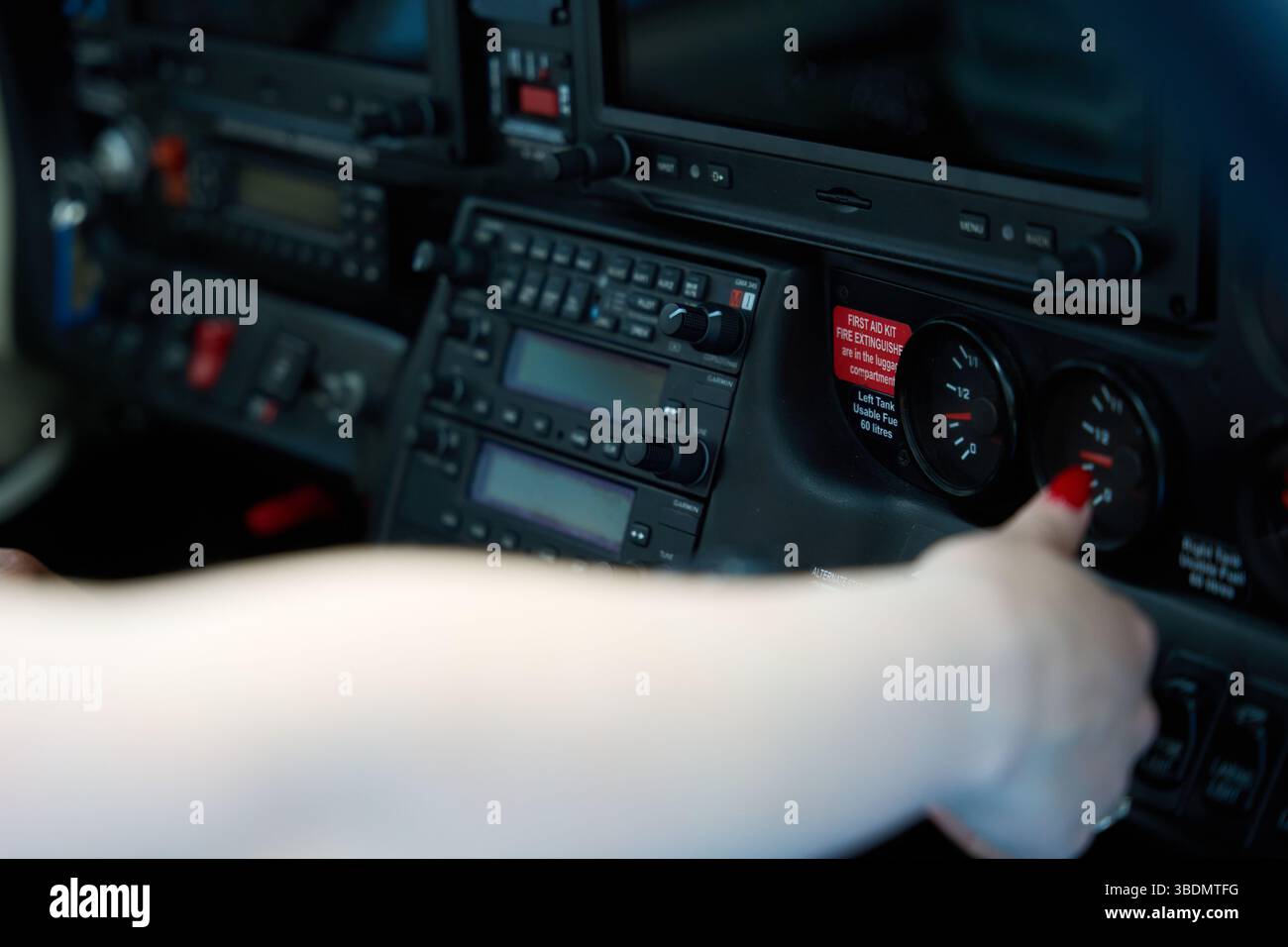 Pilot student operating aircraft cockpit controls during flight ...