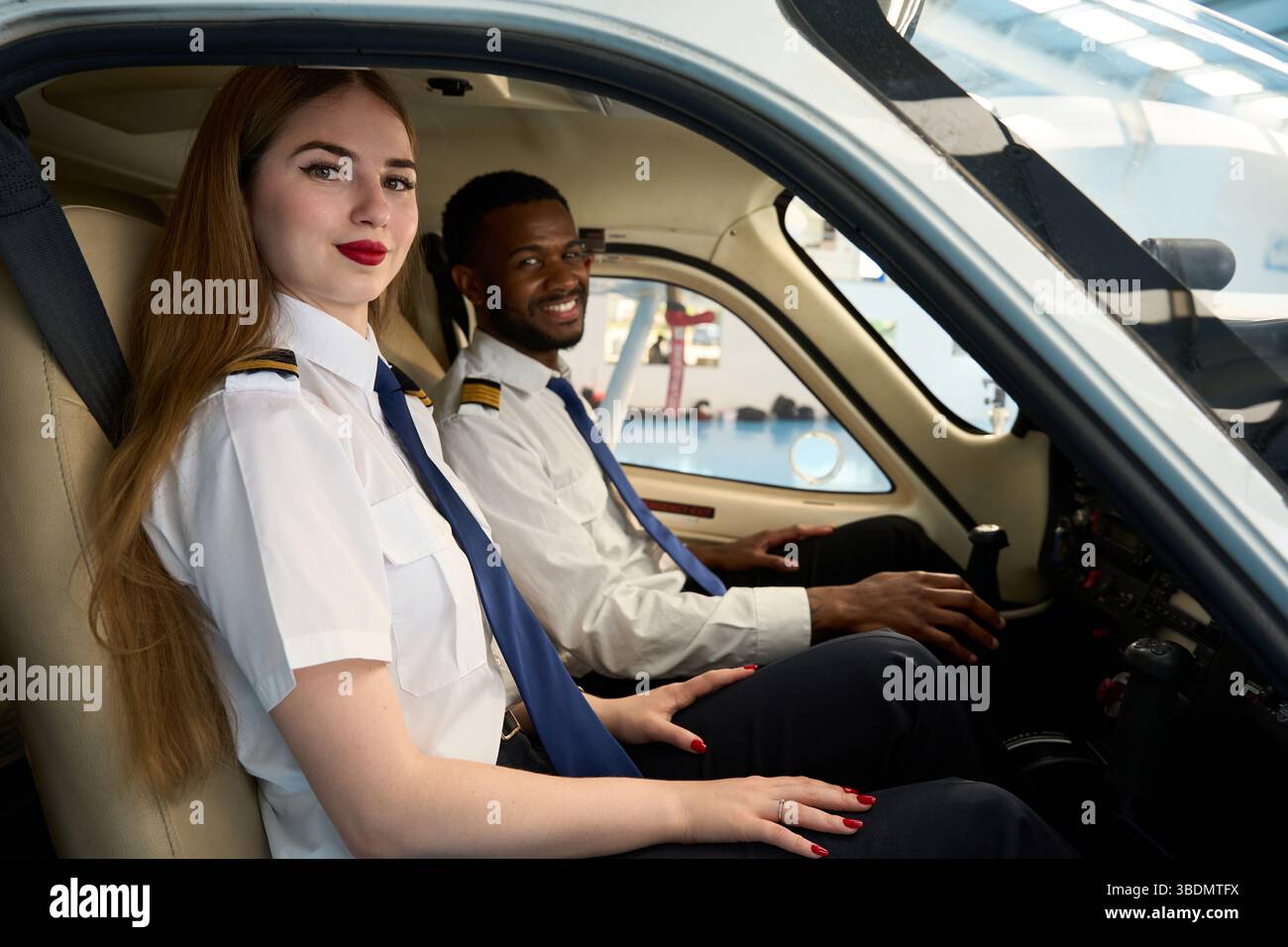 Smiling student pilots sitting in cockpit of small airplane Stock Photo ...