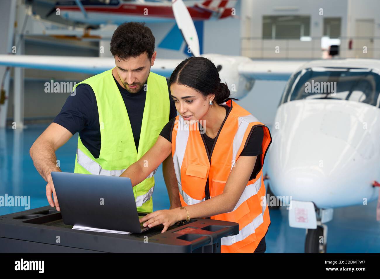 Aircraft mechanics using laptop for maintenance in hangar Stock Photo ...
