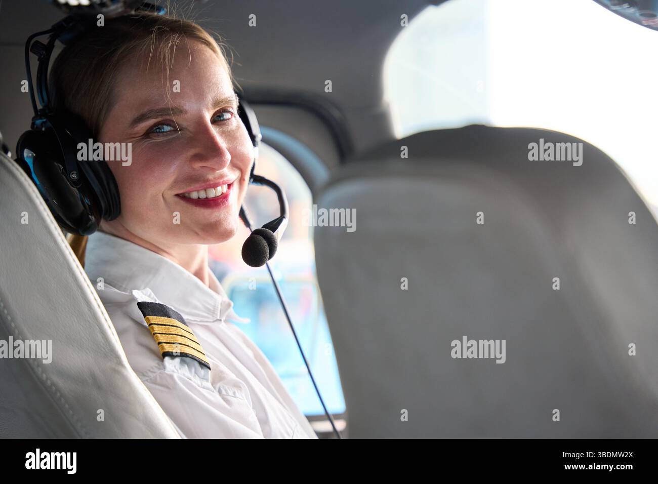 Female pilot smiling in cockpit hi-res stock photography and images - Alamy