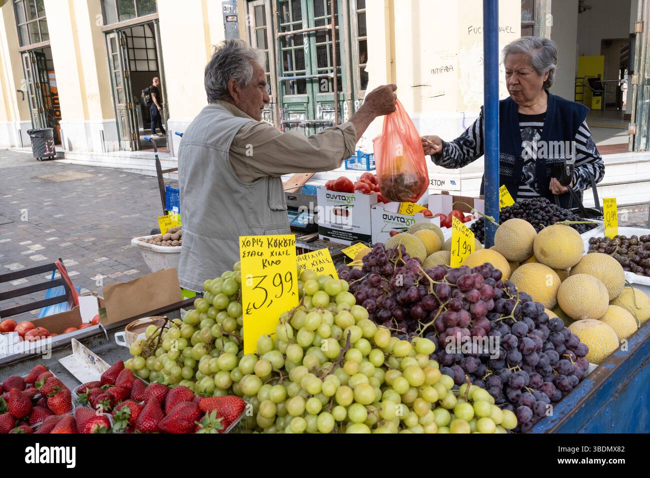 Athens, Greece. 24th Apr, 2025. A Greek woman seen buying fresh fruit ...