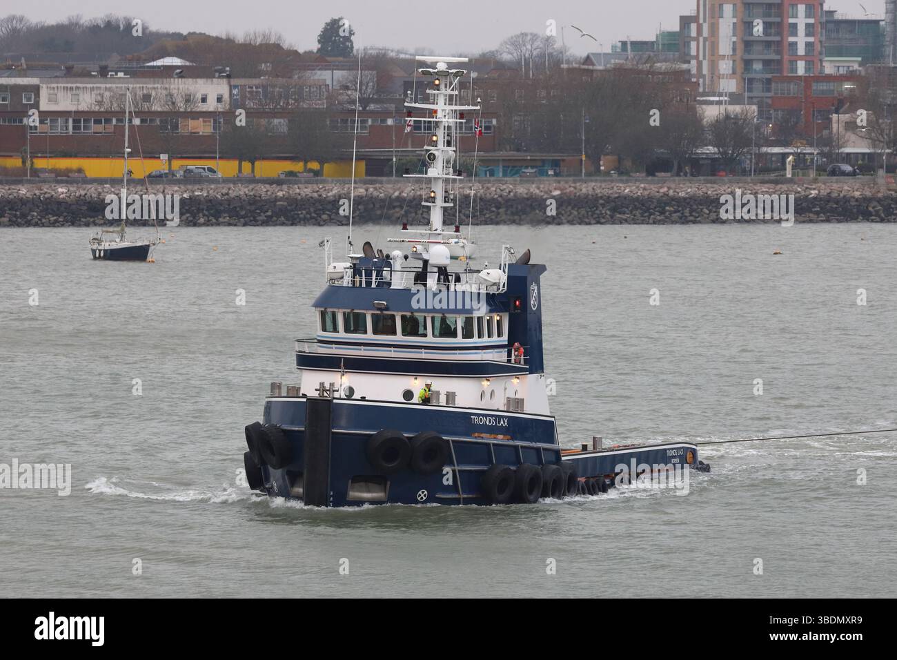 The multi purpose tug boat MV TRONDS LAX making its way out of harbour ...