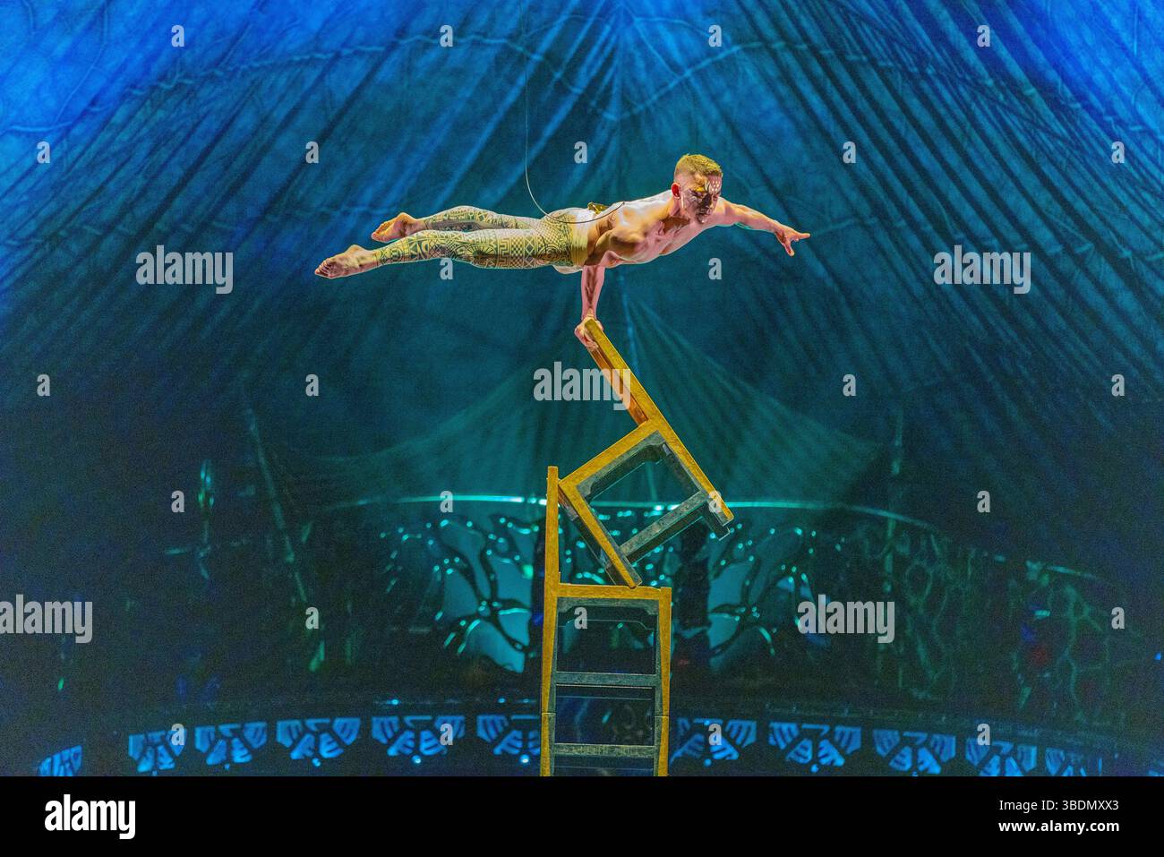 An acrobat does a flip mid-air during a media and a special Charity ...