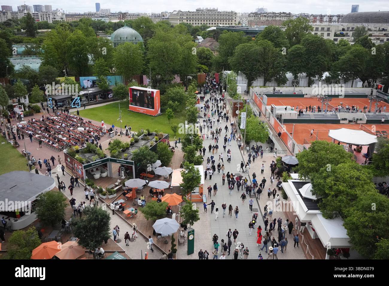 Spectators walk along courts at the Roland Garros stadium, in Paris ...