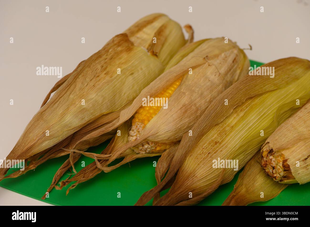 Oven Roasted Whole Corn with Rustic Flavors Stock Photo - Alamy