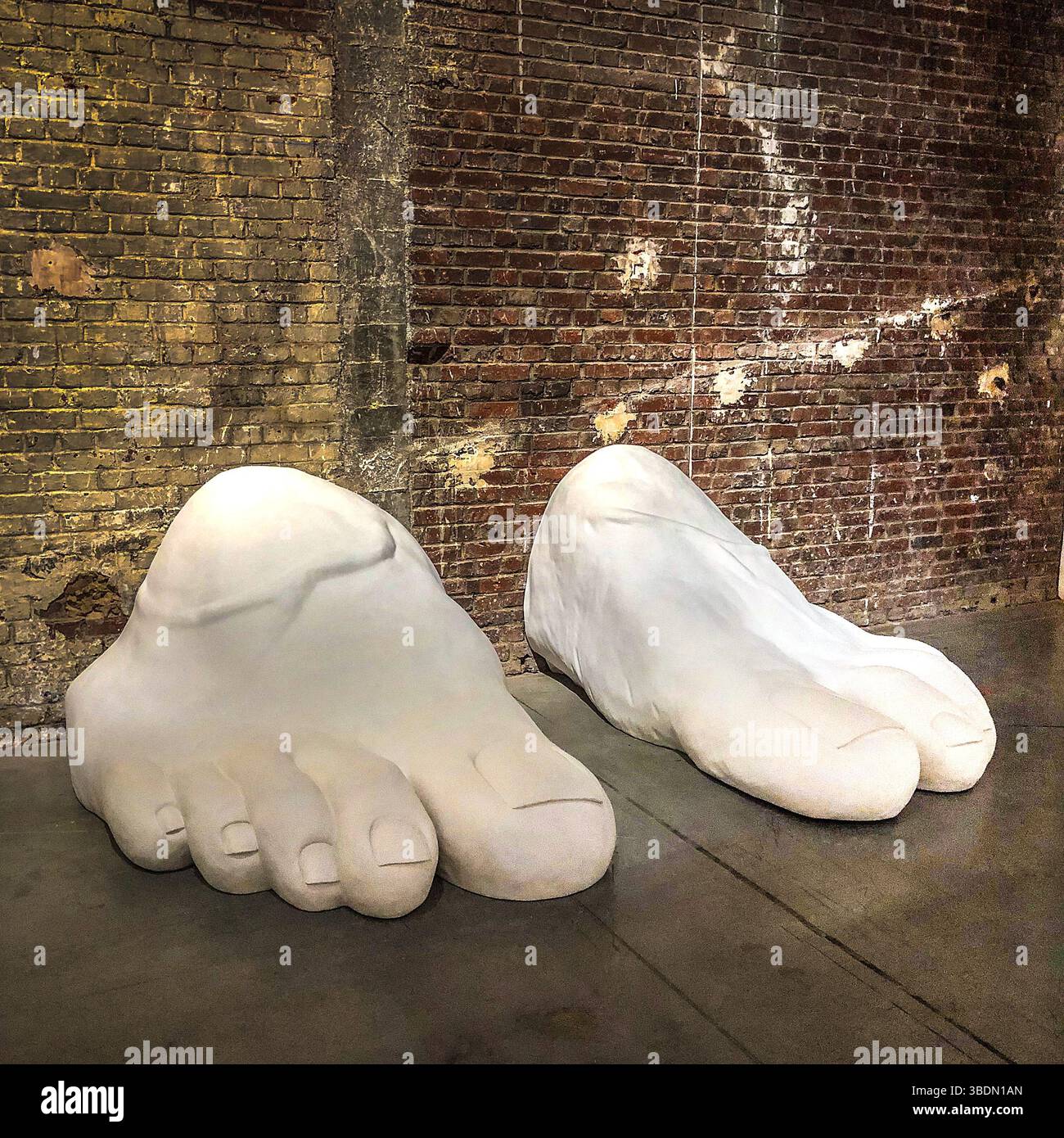 Large feet sculpture made from white jesmonite by Belgian artist Aline ...