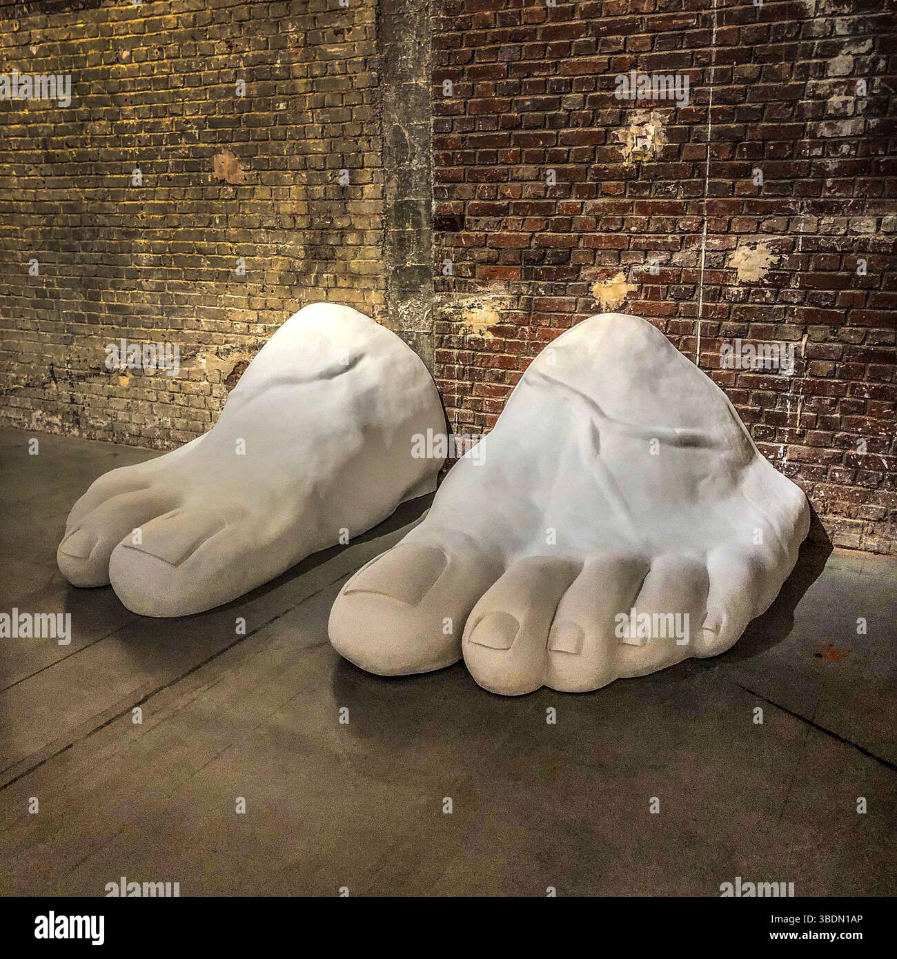 Large feet sculpture made from white jesmonite by Belgian artist Aline Bouvy in the Palais de ...