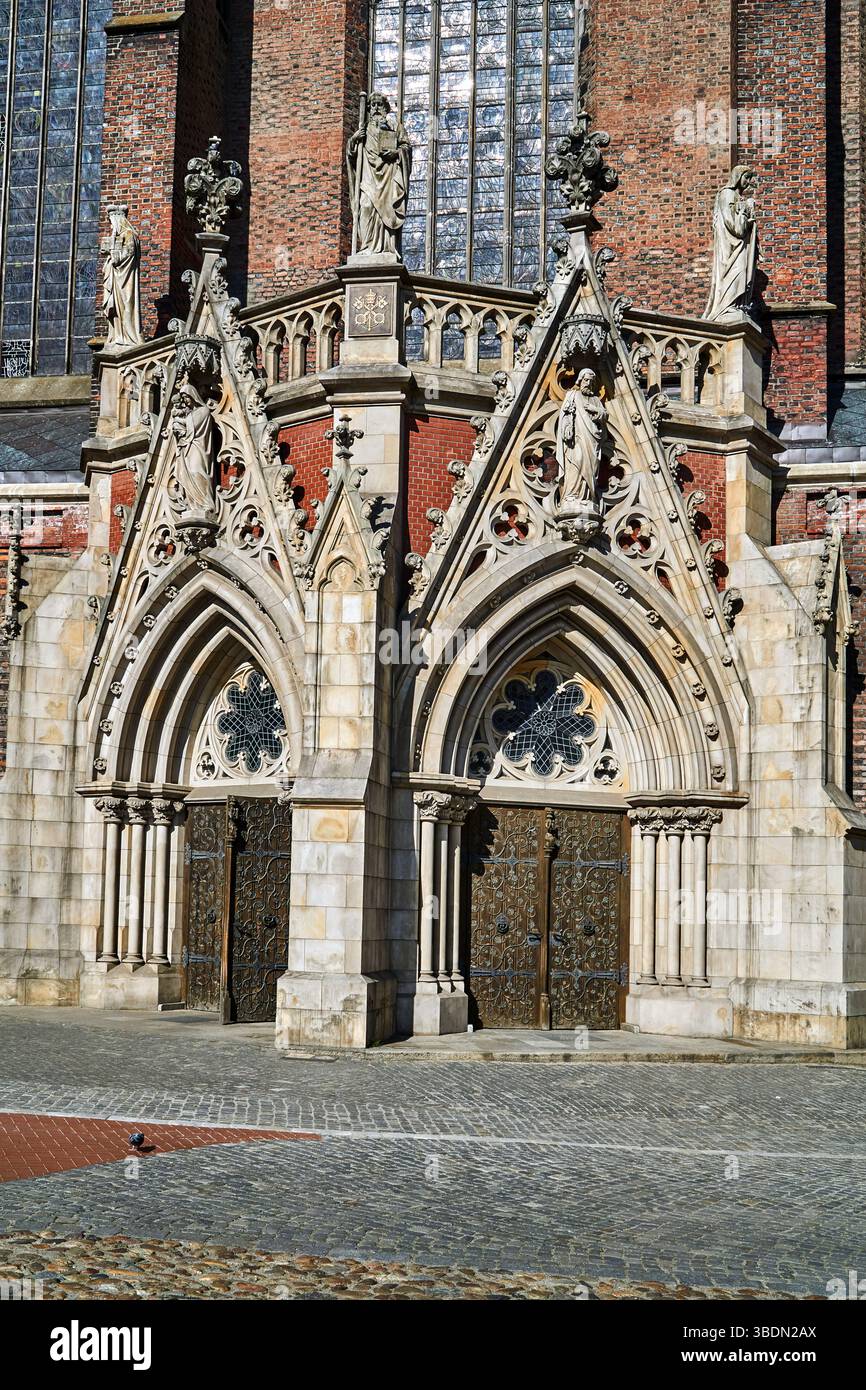 medieval facade of a gothic church with stone portals in the city of ...