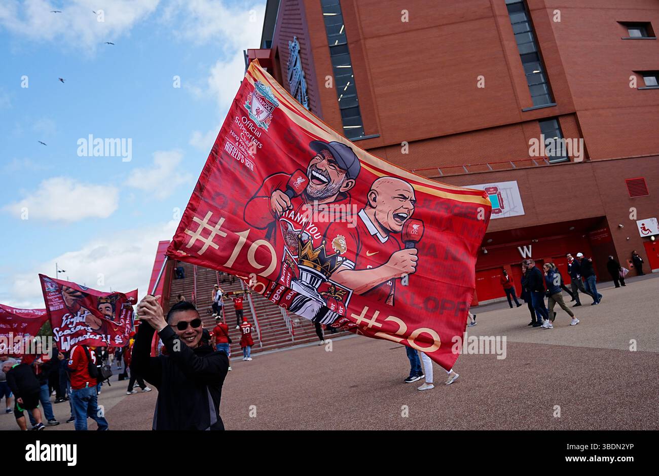 Fans with a tribute flag of Liverpool manager Arne Slot and former ...