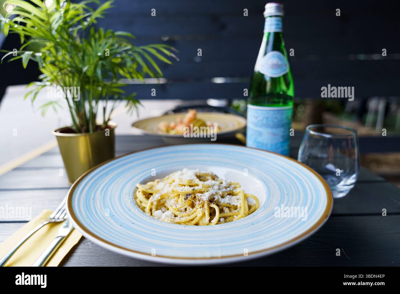 A plate of authentic Italian cacio e pepe pasta, featuring al dente ...