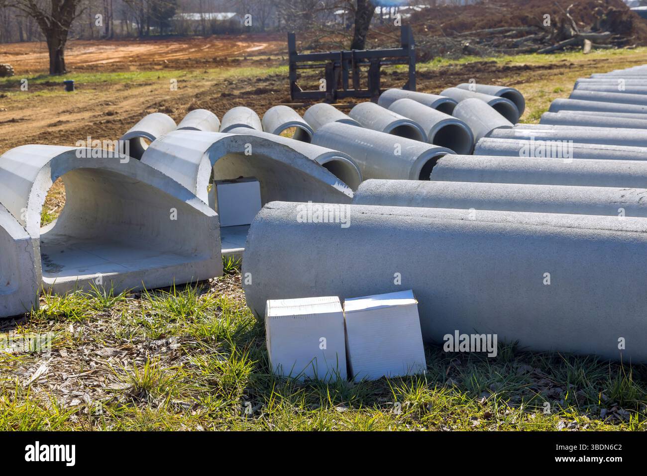 Concrete pipes blocks are neatly arranged on construction site in rural ...
