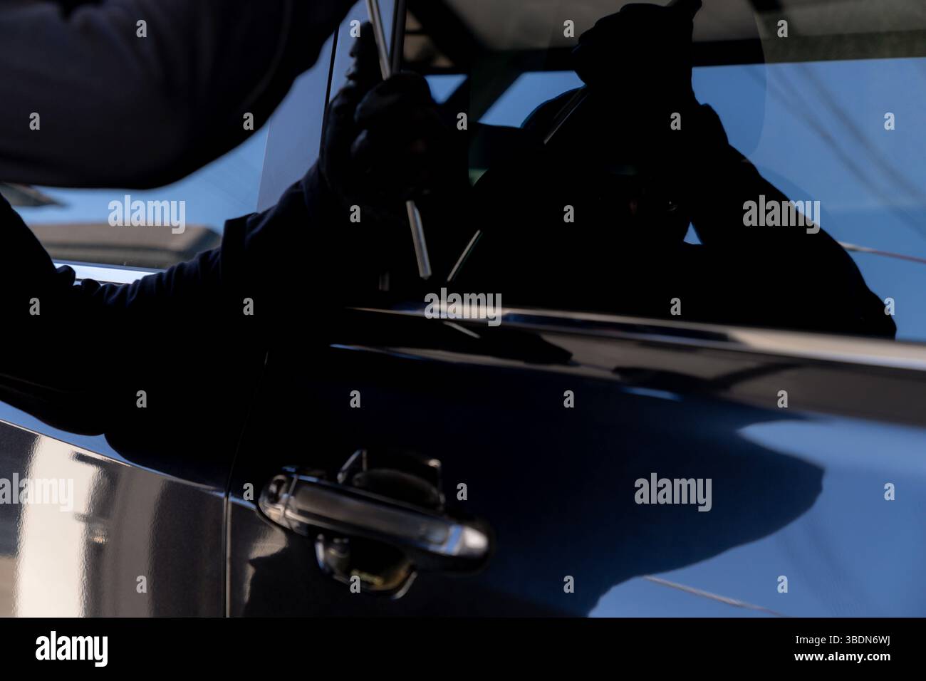 Car burglary in progress, highlighting the importance of vehicle ...