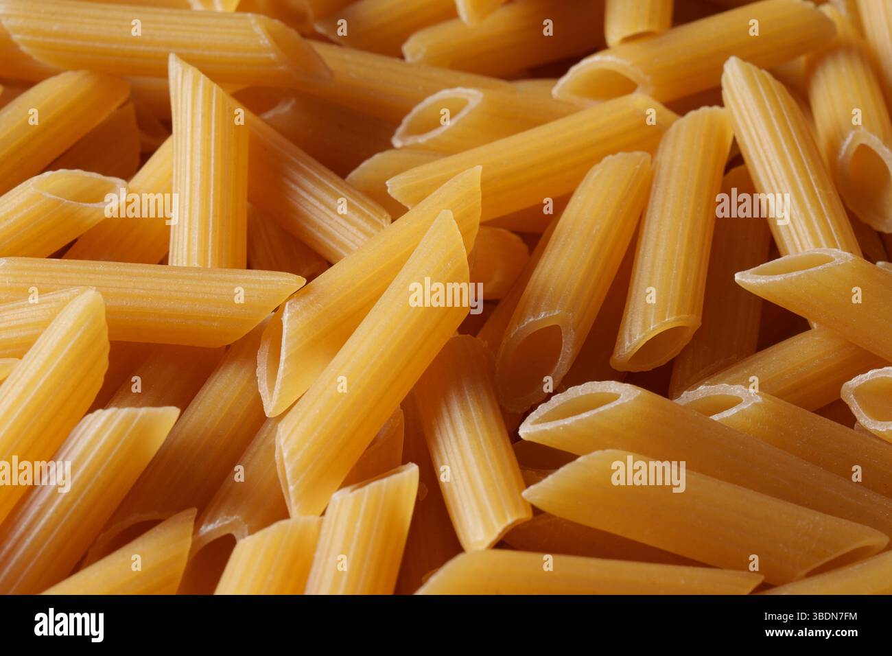 Raw organic penne pasta, top view. Lots of pasta Stock Photo - Alamy