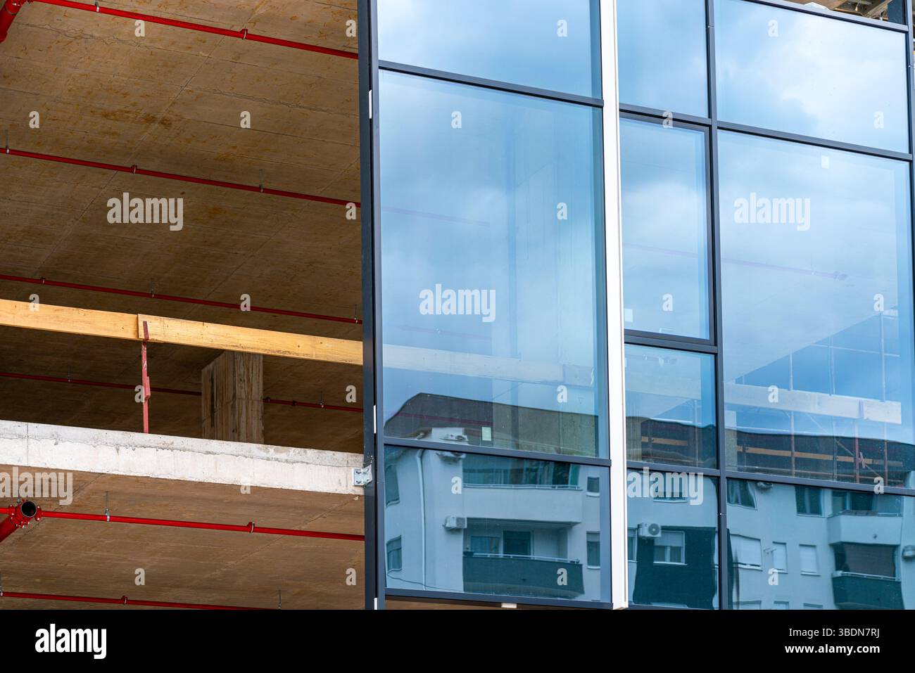 Installation of unitized glass curtain wall panel on modern concrete ...