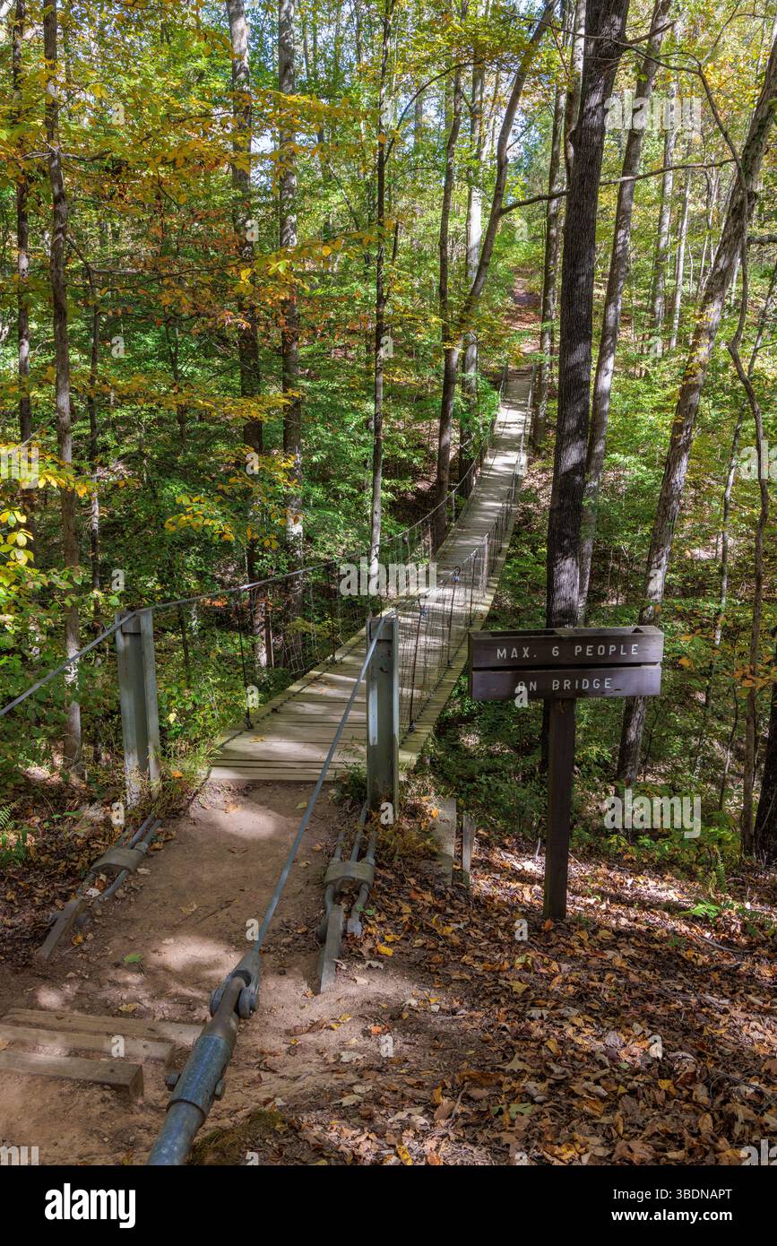 Sign limits the number of people that can cross a suspension bridge ...