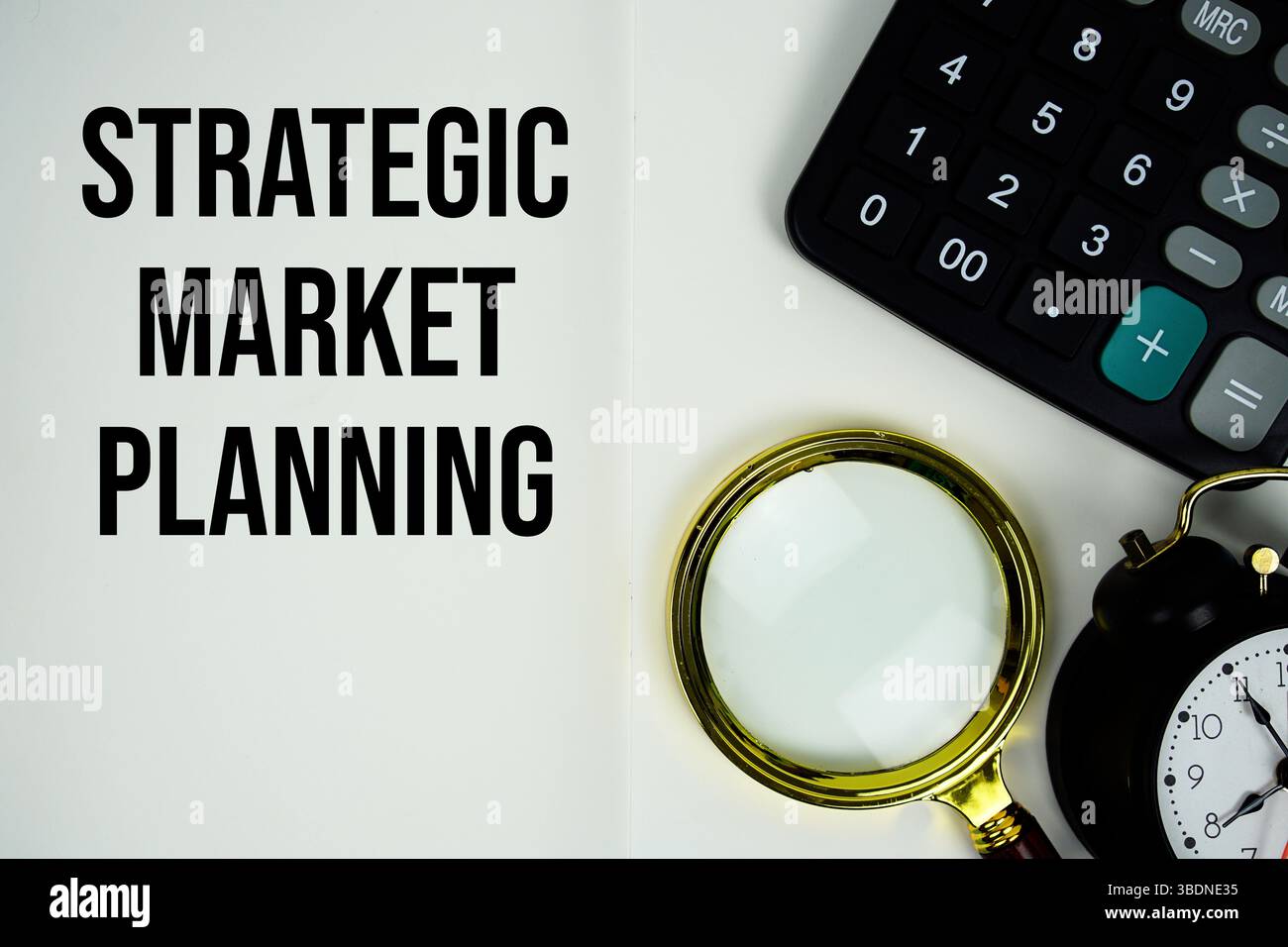 Strategic Market Planning text with alarm clock, magnifying glass and ...
