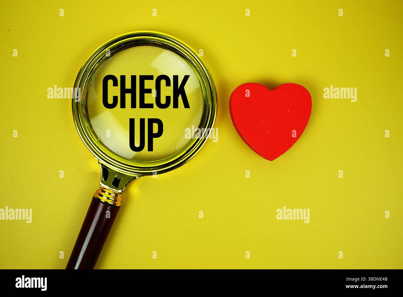 Check Up text with magnifying and red heart on yellow background Stock ...