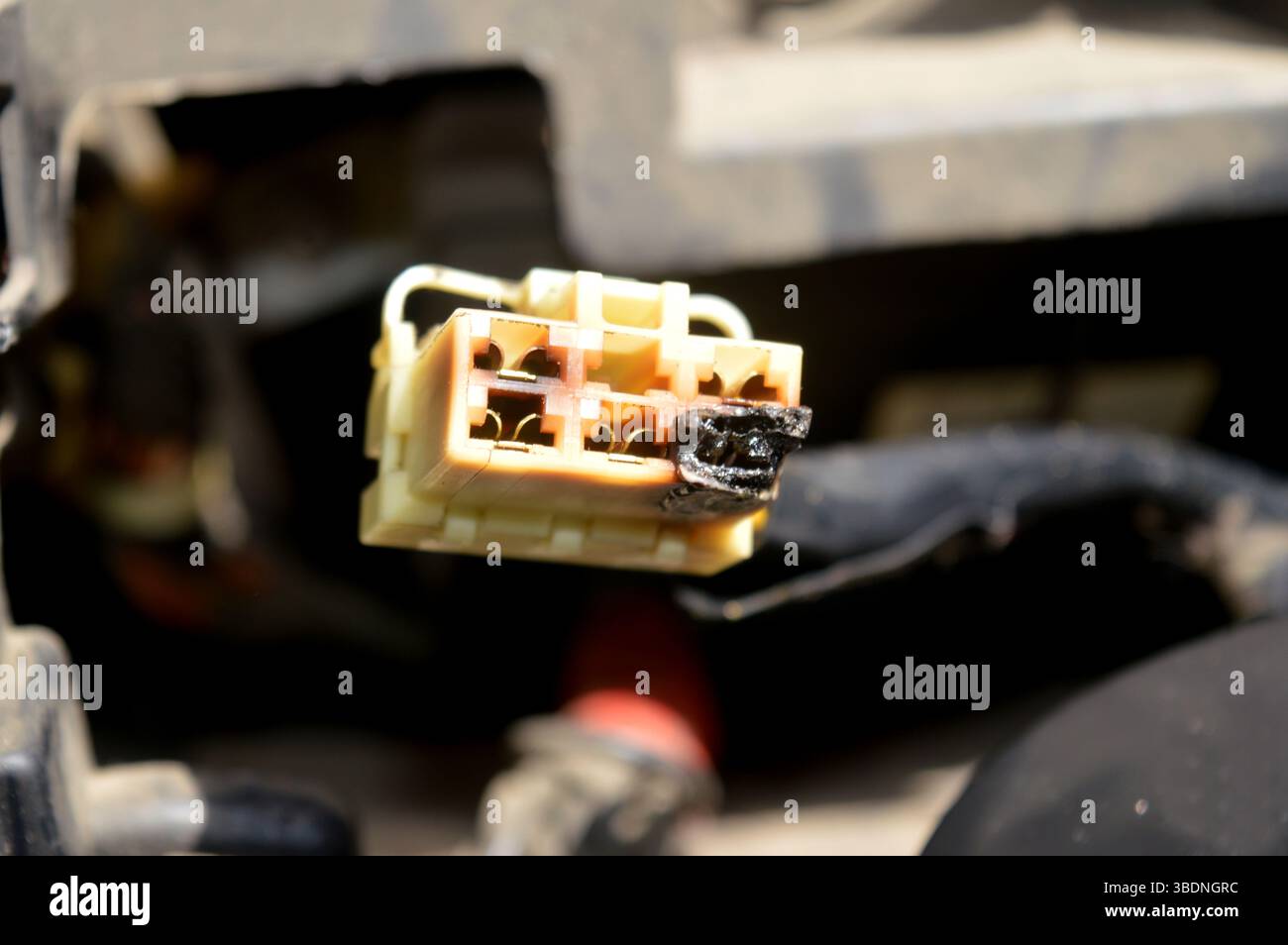 A burnt plug in the car electricity system connected to the wires that ...