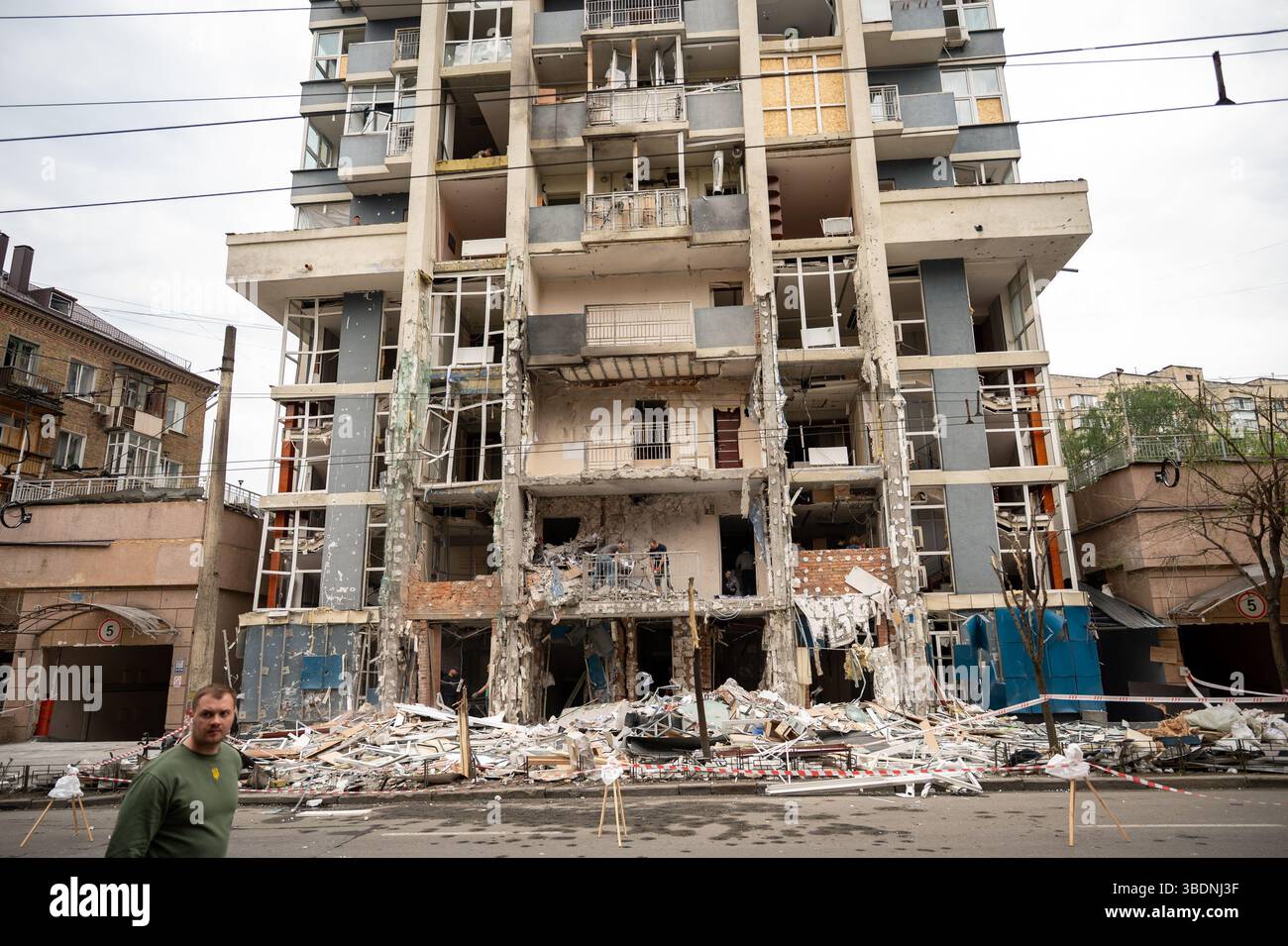 Construction workers clear damage from a combined drone and missile ...