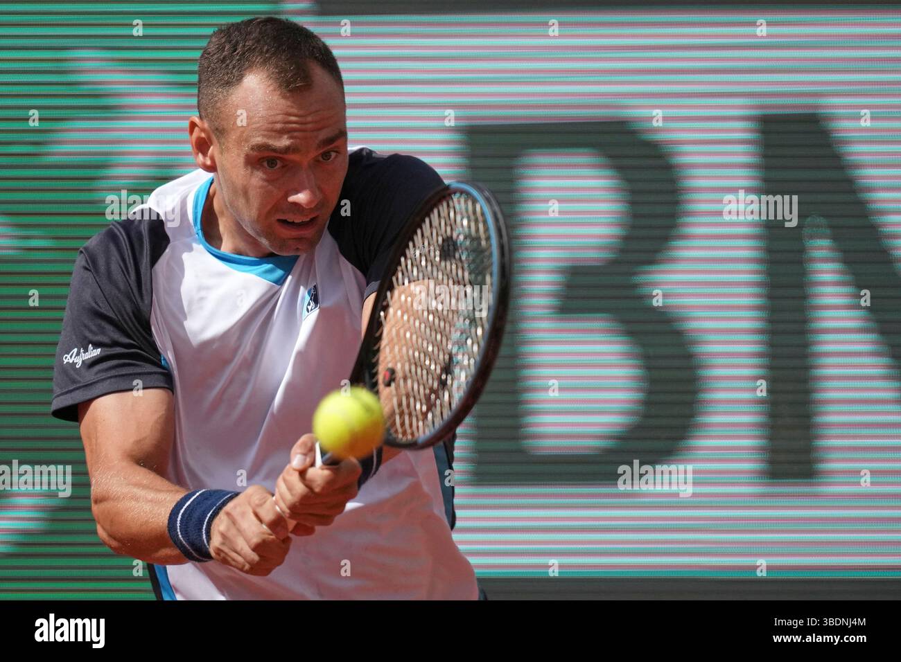 Russia's Roman Safiullin returns the ball to Frances Tiafoe of the U.S ...