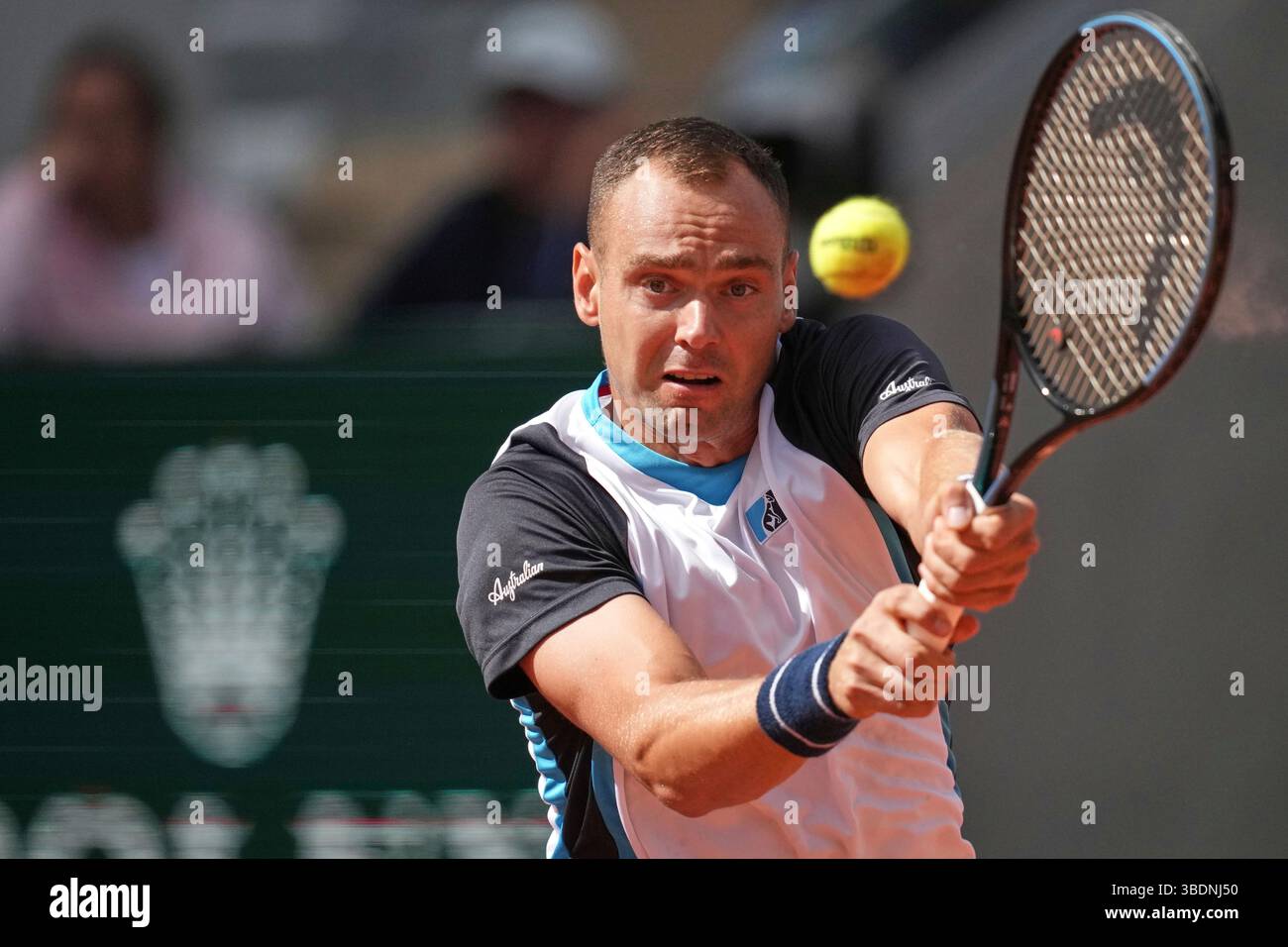 Russia's Roman Safiullin returns the ball to Frances Tiafoe of the U.S ...