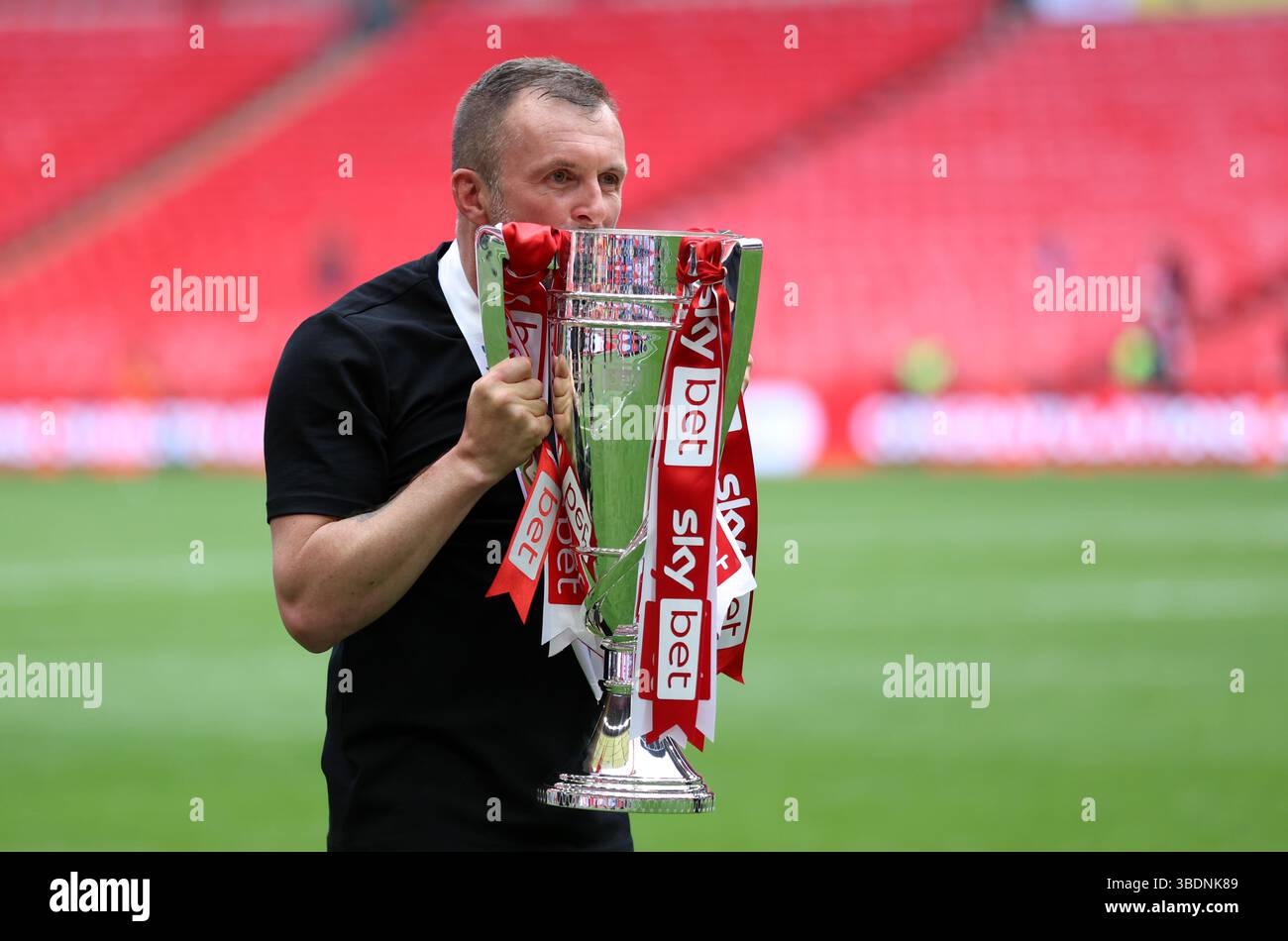Charlton Athletic manager Nathan Jones with the trophy after winning the Sky Bet League One play ...