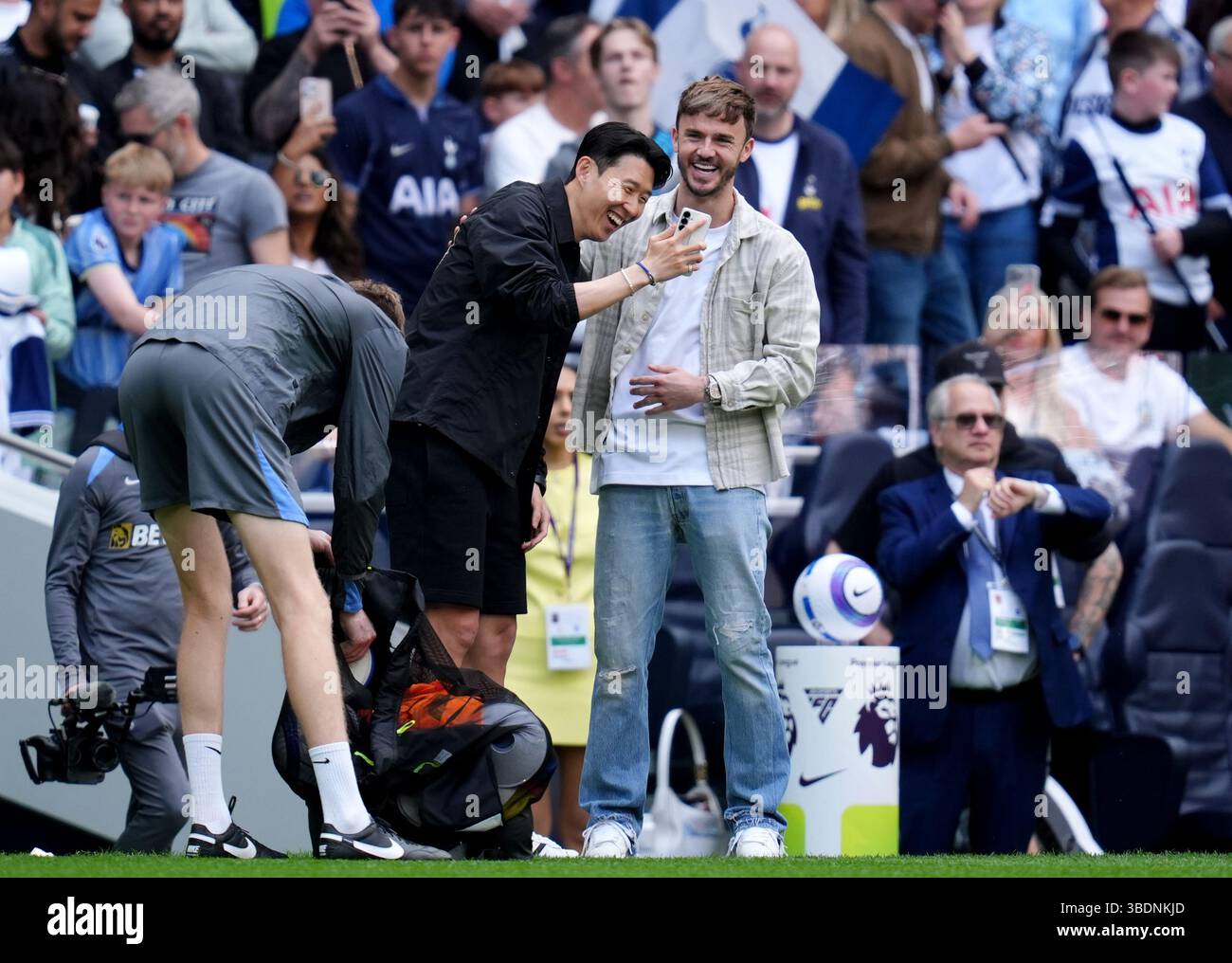 Tottenham Hotspur's Son Heung-Min (left) and James Maddison pitch side ...